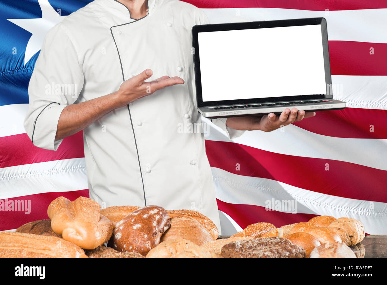 Liberian Baker holding laptop on Liberia flag and breads background ...