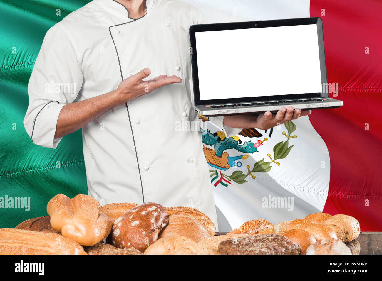 Mexican Baker holding laptop on Mexico flag and breads background. Chef ...