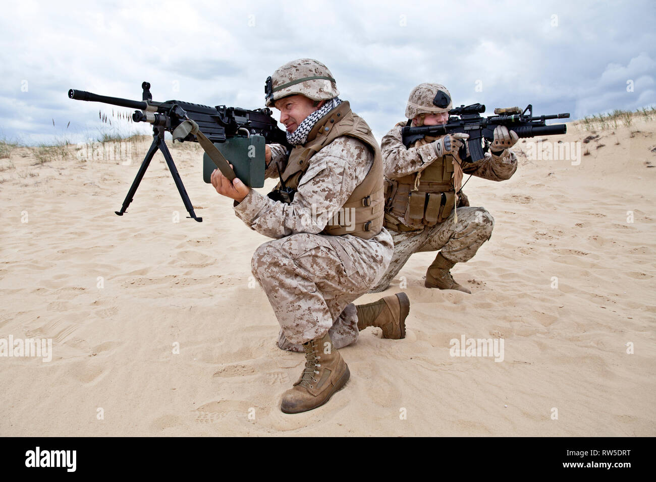 Two U.S. Marines aim at different directions covering each other Stock ...