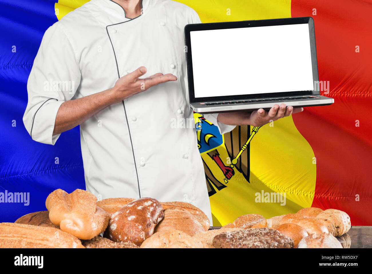 Moldovan Baker holding laptop on Moldova flag and breads background ...