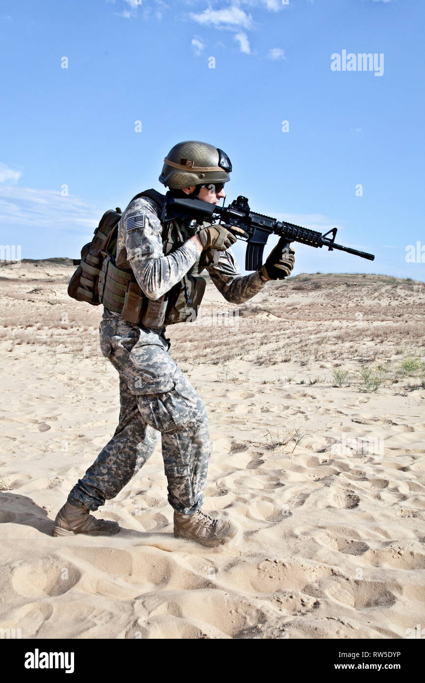 U.S. soldier going through the desert during the military operation ...