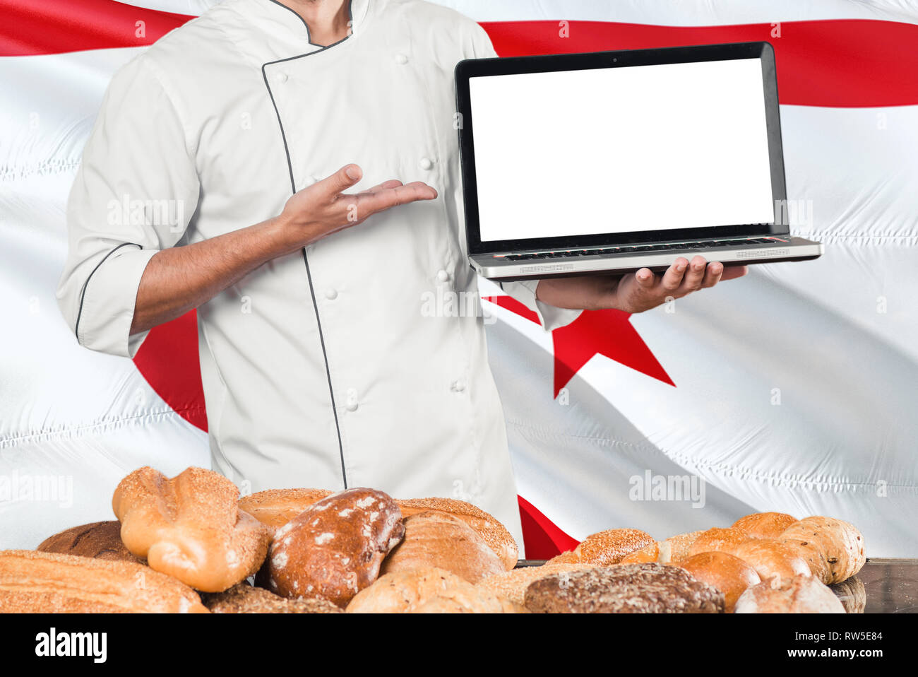 Turkish Baker holding laptop on Northern Cyprus flag and breads ...