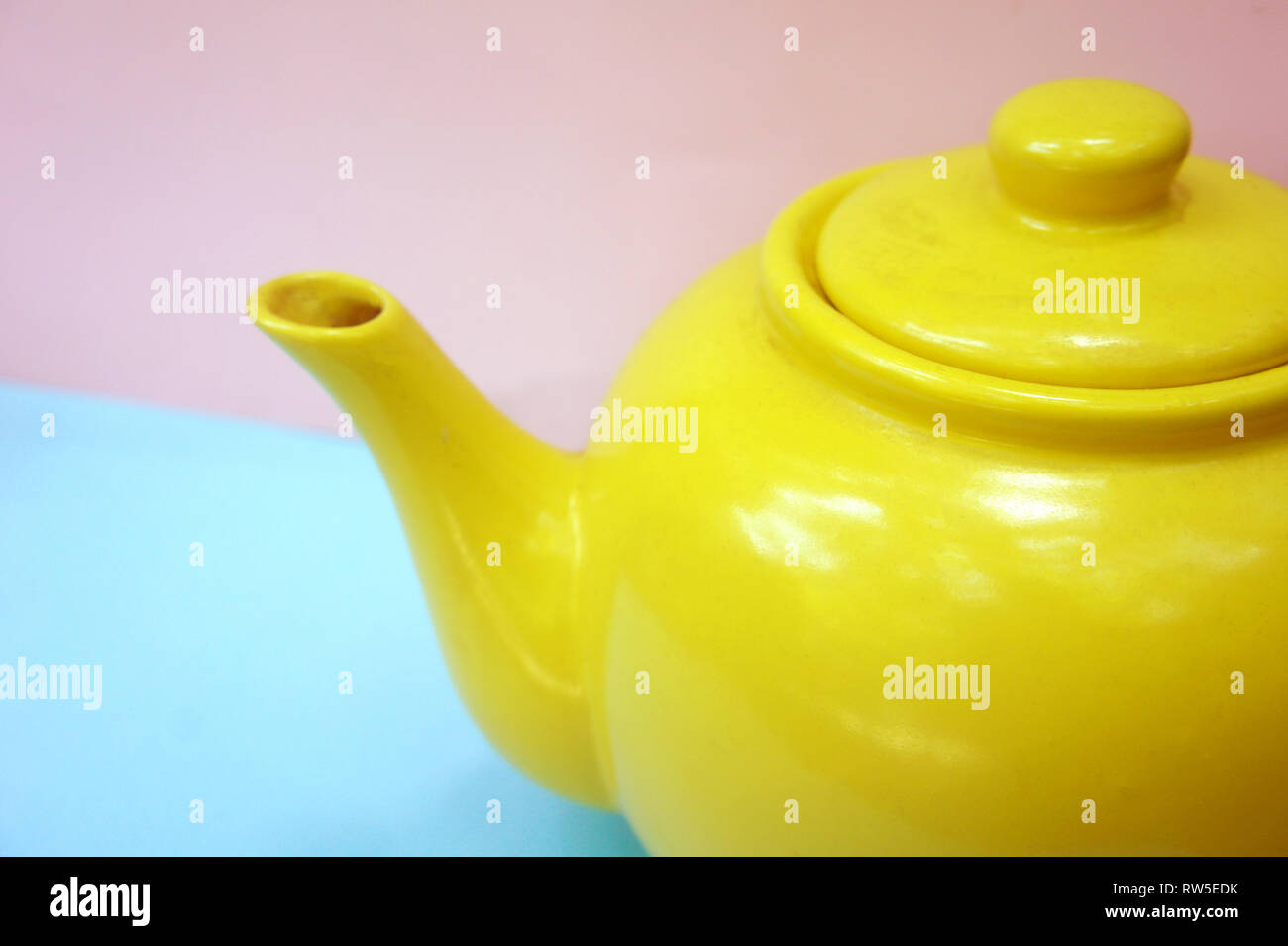 teapot on pastel blue pink background in modern design concept. yellow ...