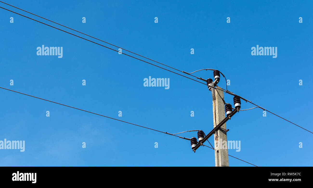 Concrete Electric Pylon or Post with Electric Wires Against Clear Blue ...