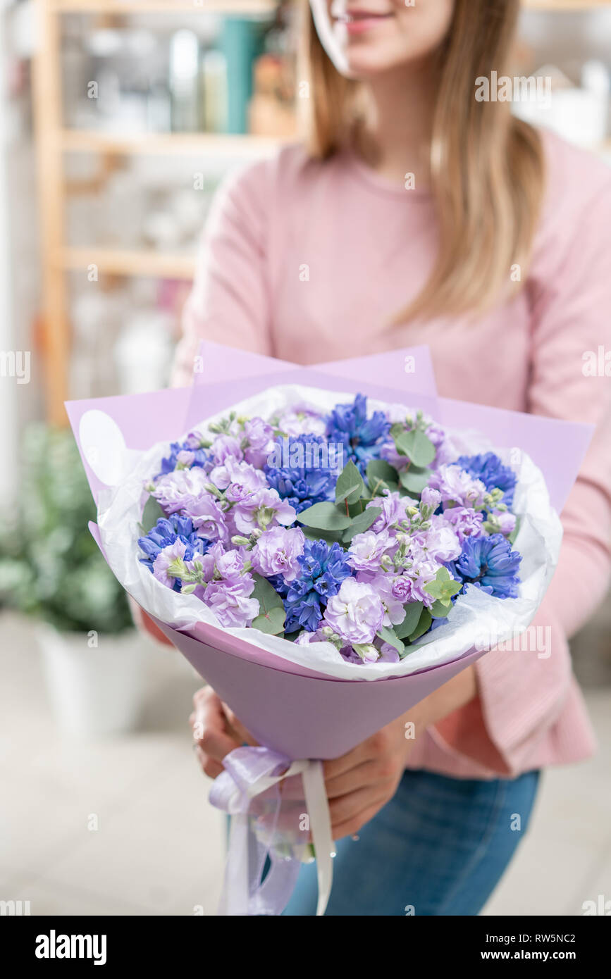 Bouquets of blue hyacinths and matthiola of lilac color in woman hand ...