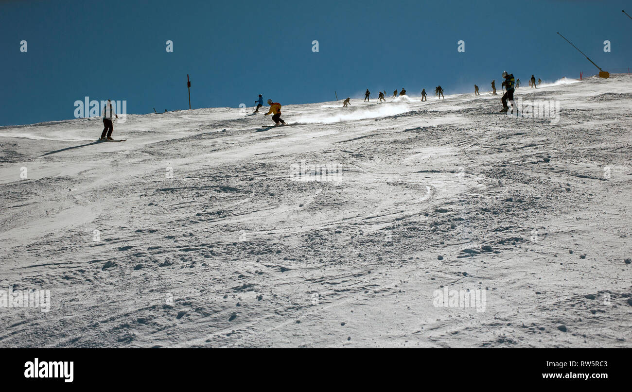 Lots of skiers and snowboarders on a slope at sky resort Stock Photo ...
