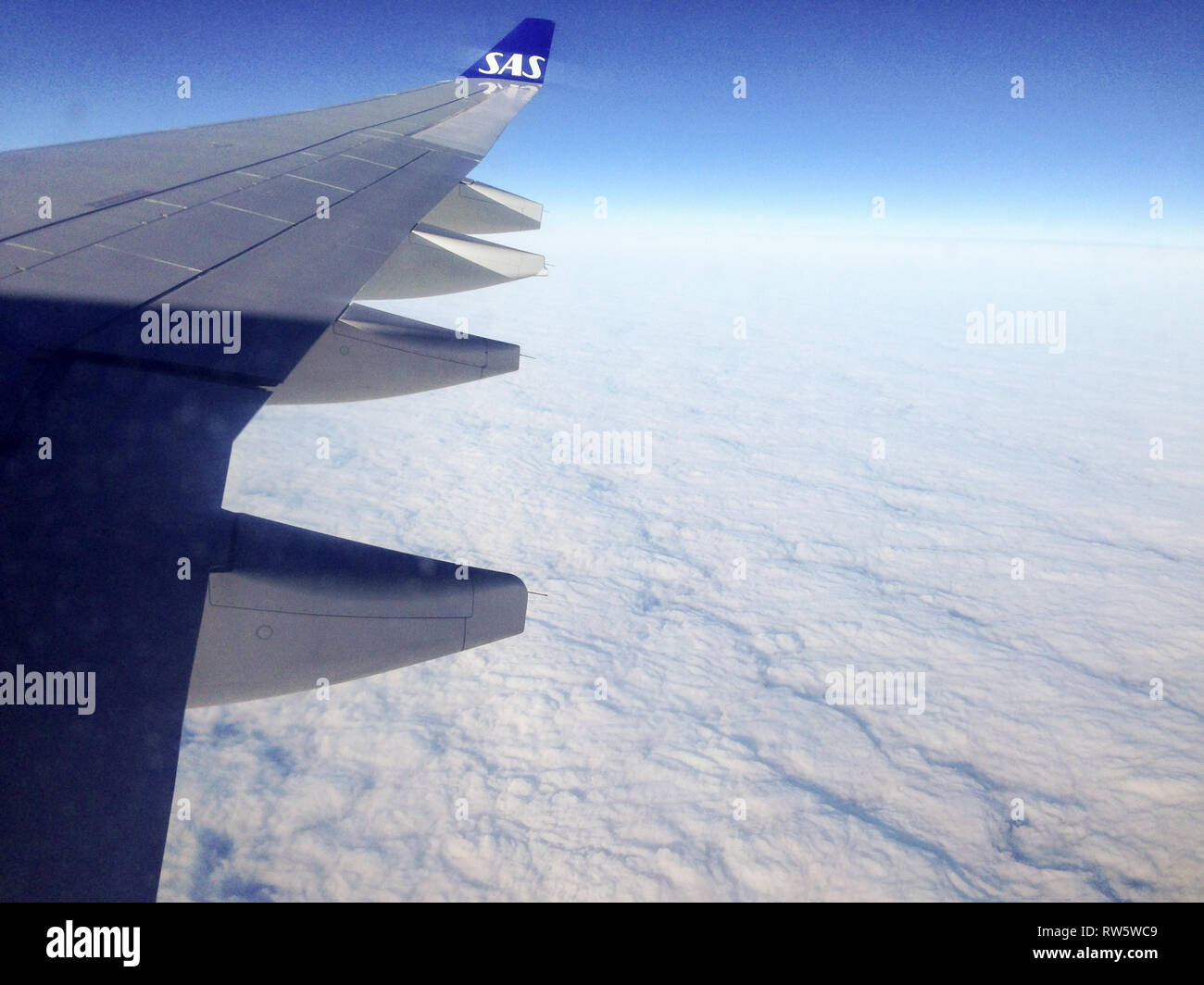 View out of a SAS plane above clouds with view of the wing Stock Photo ...