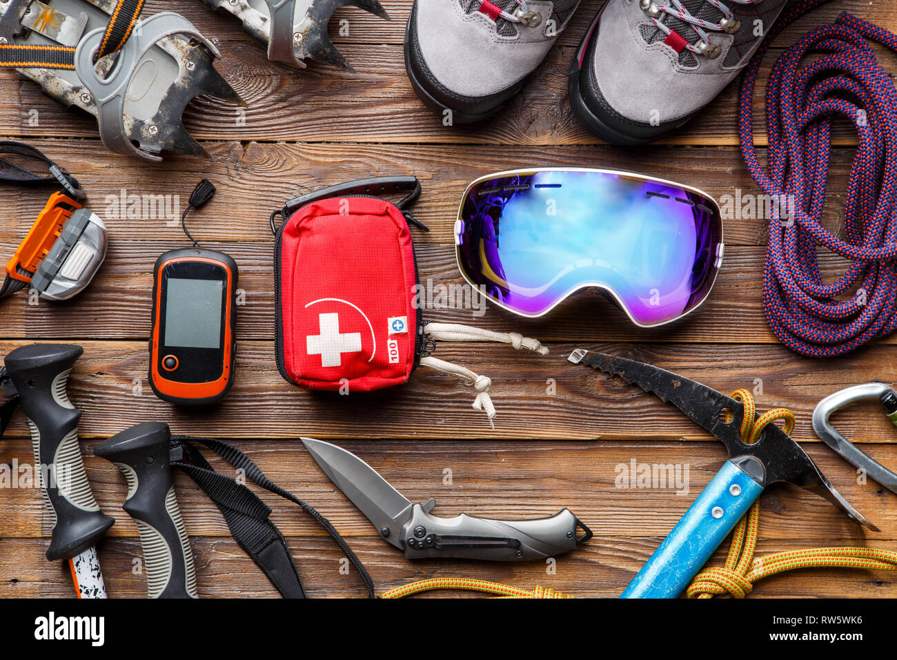 Photo from above of ski poles, boots, pickaxe, first aid kits, masks on ...