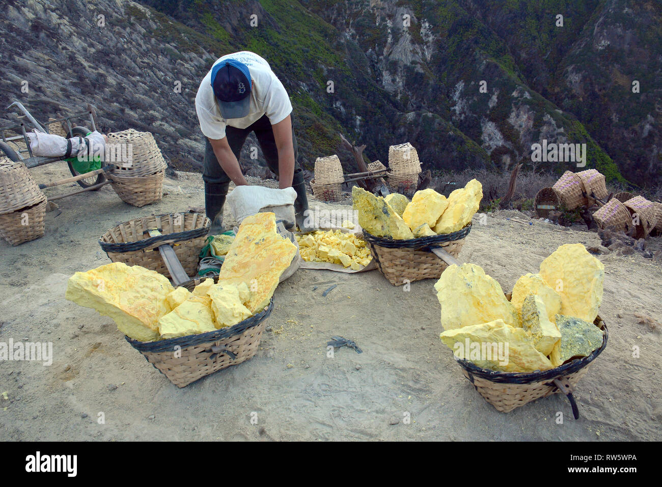 Sulfur miner at Kawah Ijen volcano crater in Java, Indonesia Stock ...