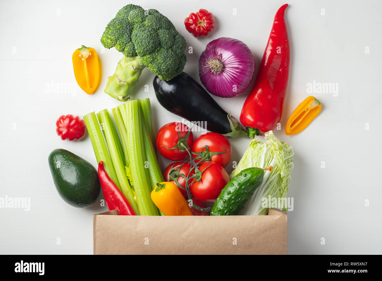 Paper bag with fresh vegetables on white background. Flat lay. Top view ...