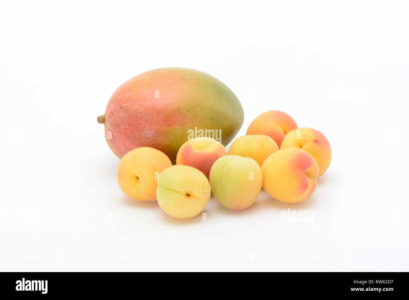 Apricots and mango on white background Stock Photo - Alamy