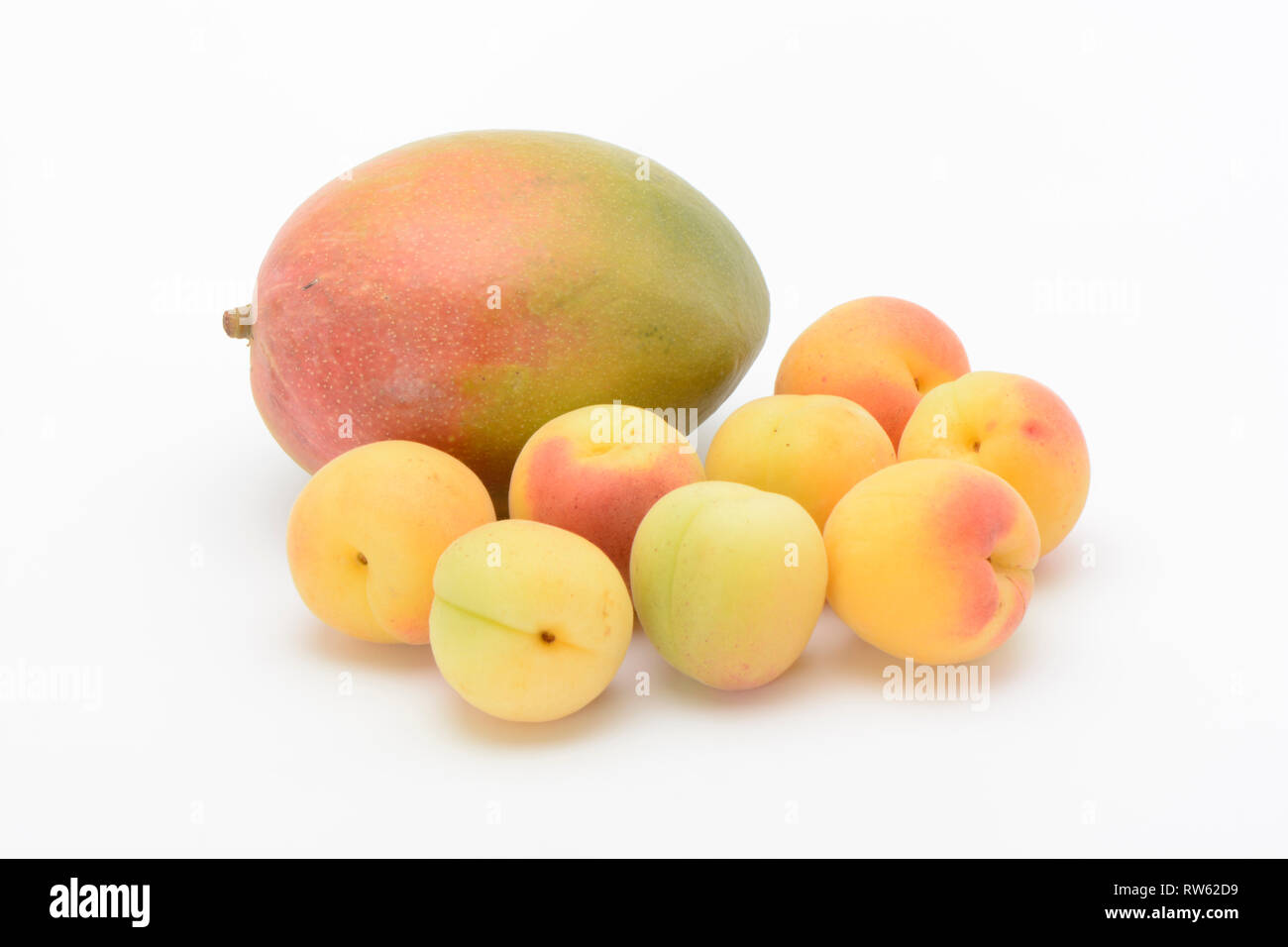 Apricots and mango on white background Stock Photo - Alamy