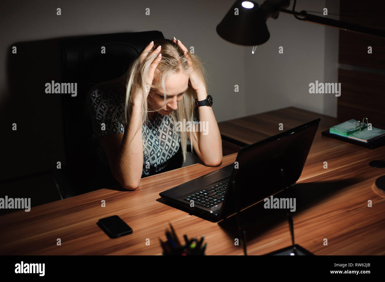 Portrait of stressed businesswoman sitting at office desk and thinking ...