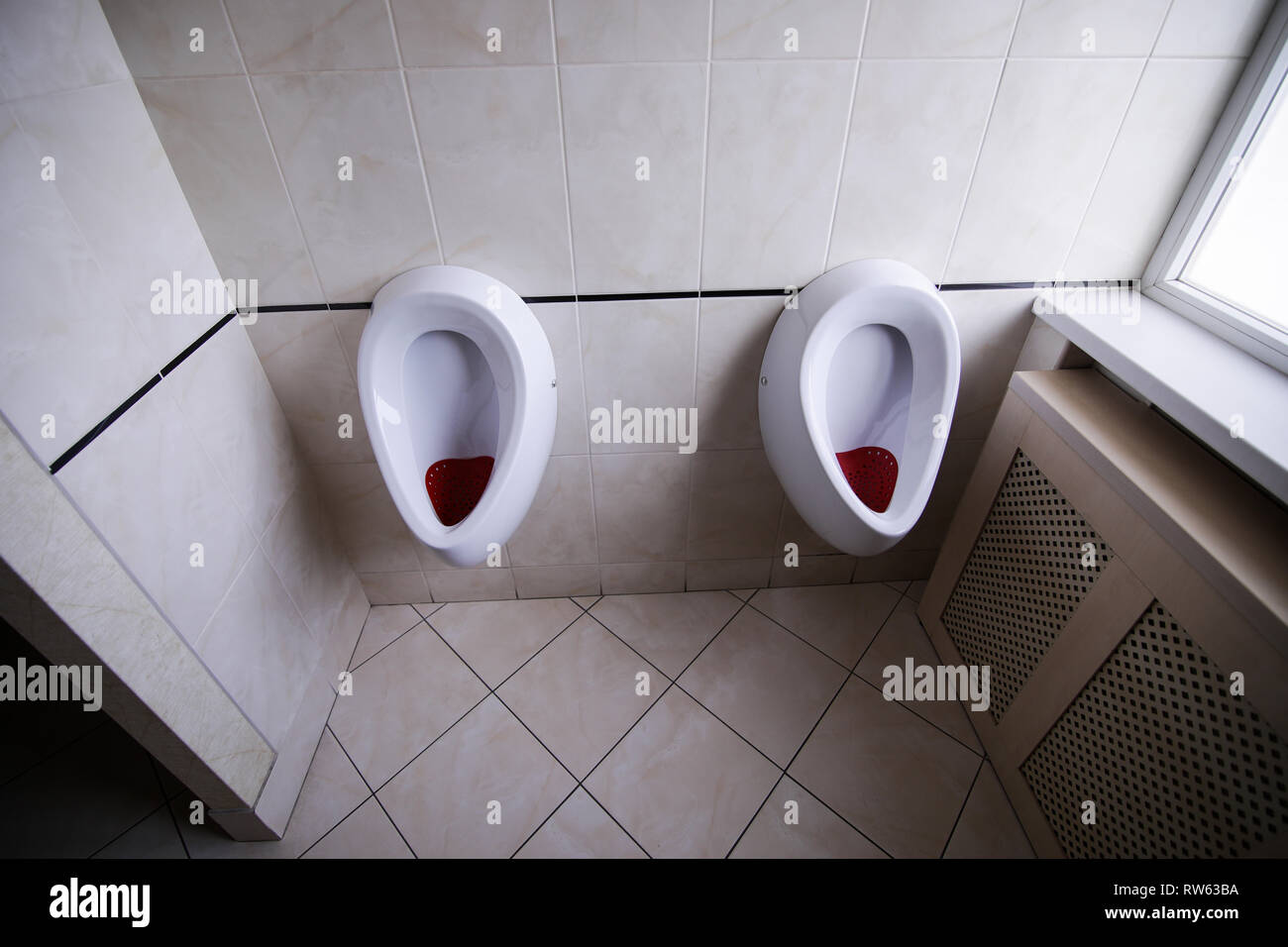 Two urinals in men restroom Stock Photo - Alamy