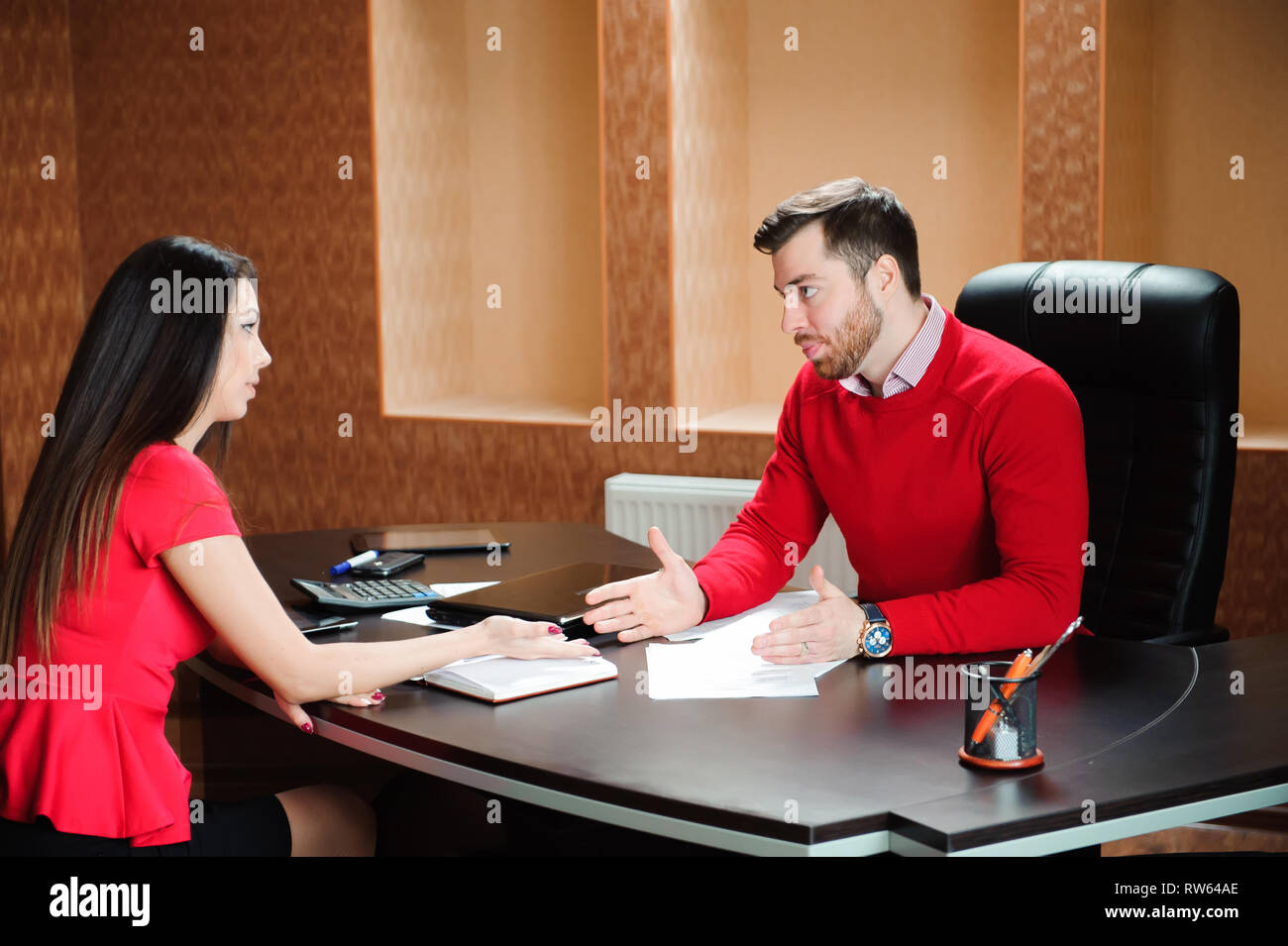 Friendly smiling businessman and businesswoman handshaking over the ...