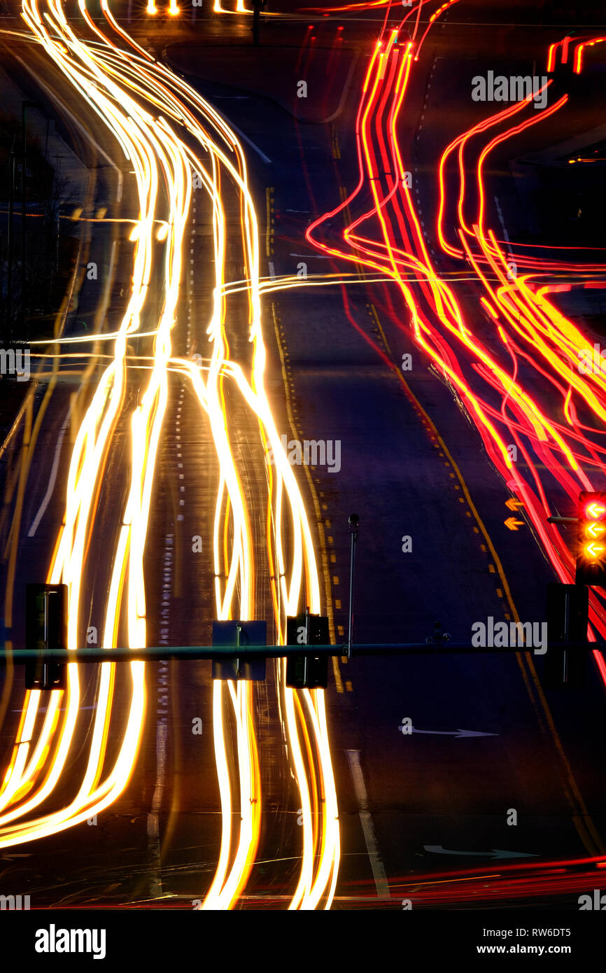Driving in traffic at night dark with lights streak on road or highway ...