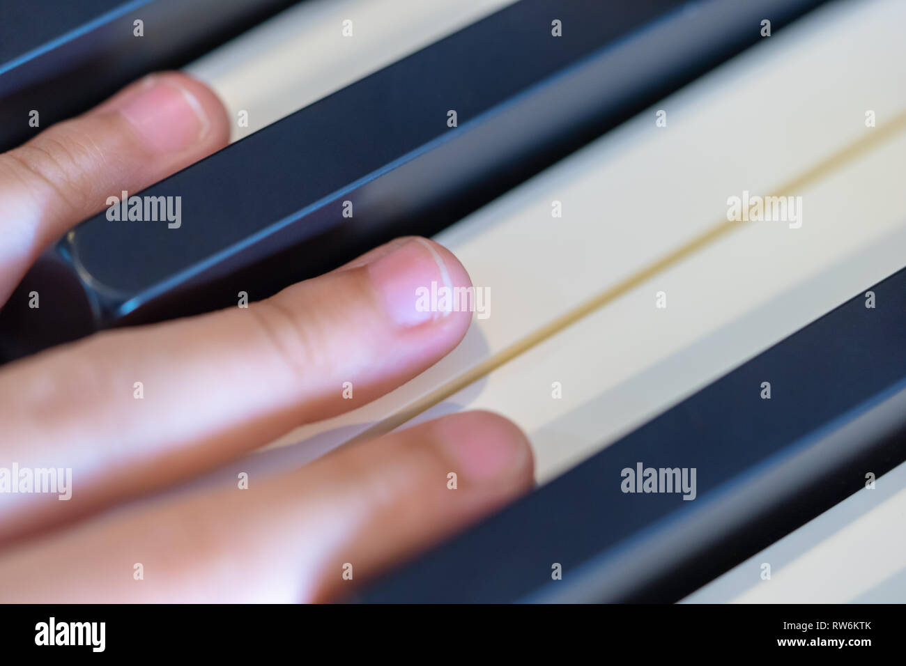 Hand playing Music keyboard piano closed up Stock Photo - Alamy