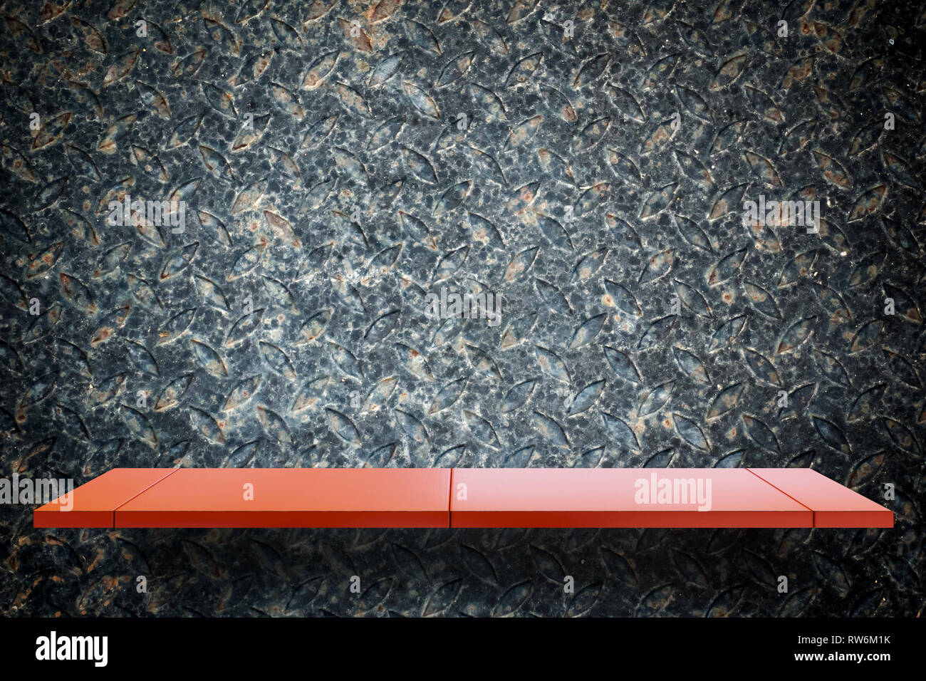 Empty red metal display shelf on grungy metal background for product ...