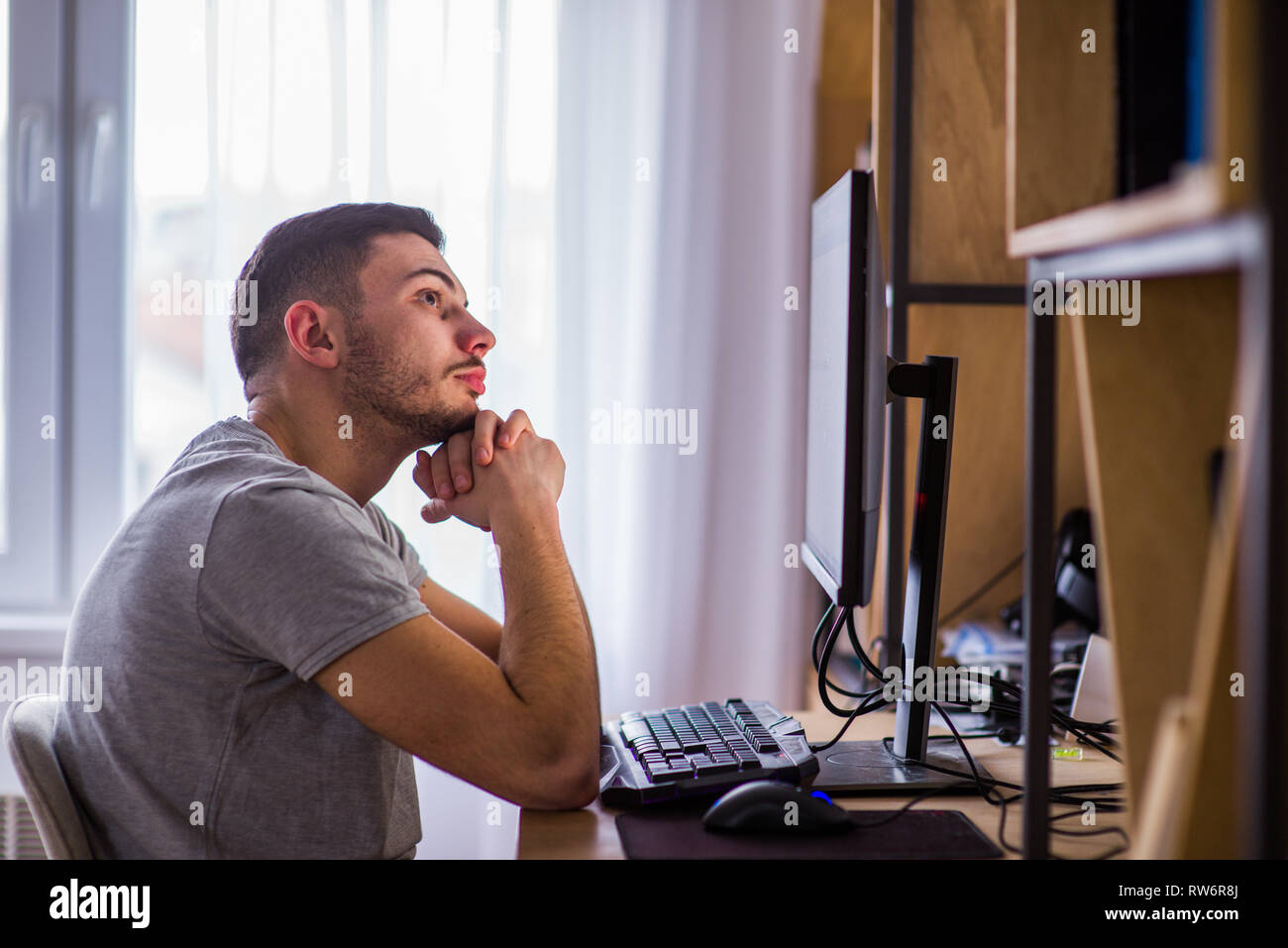 Concentrated gamer playing first hi-res stock photography and images ...