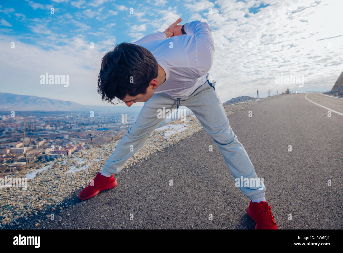 Fit male stretching and performing his morning routines while wearing a ...