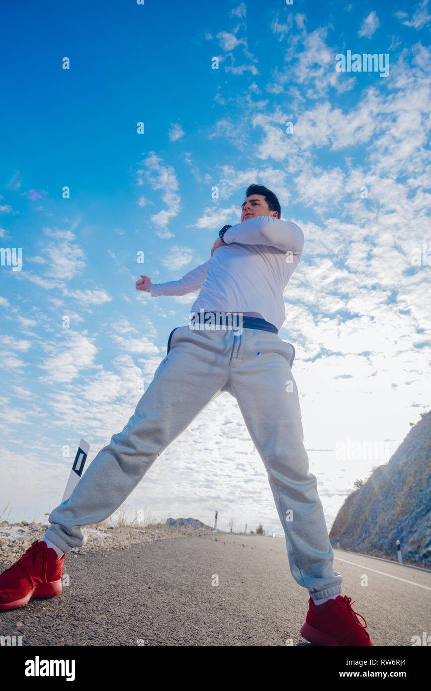 Fit male stretching and performing his morning routines while wearing a ...