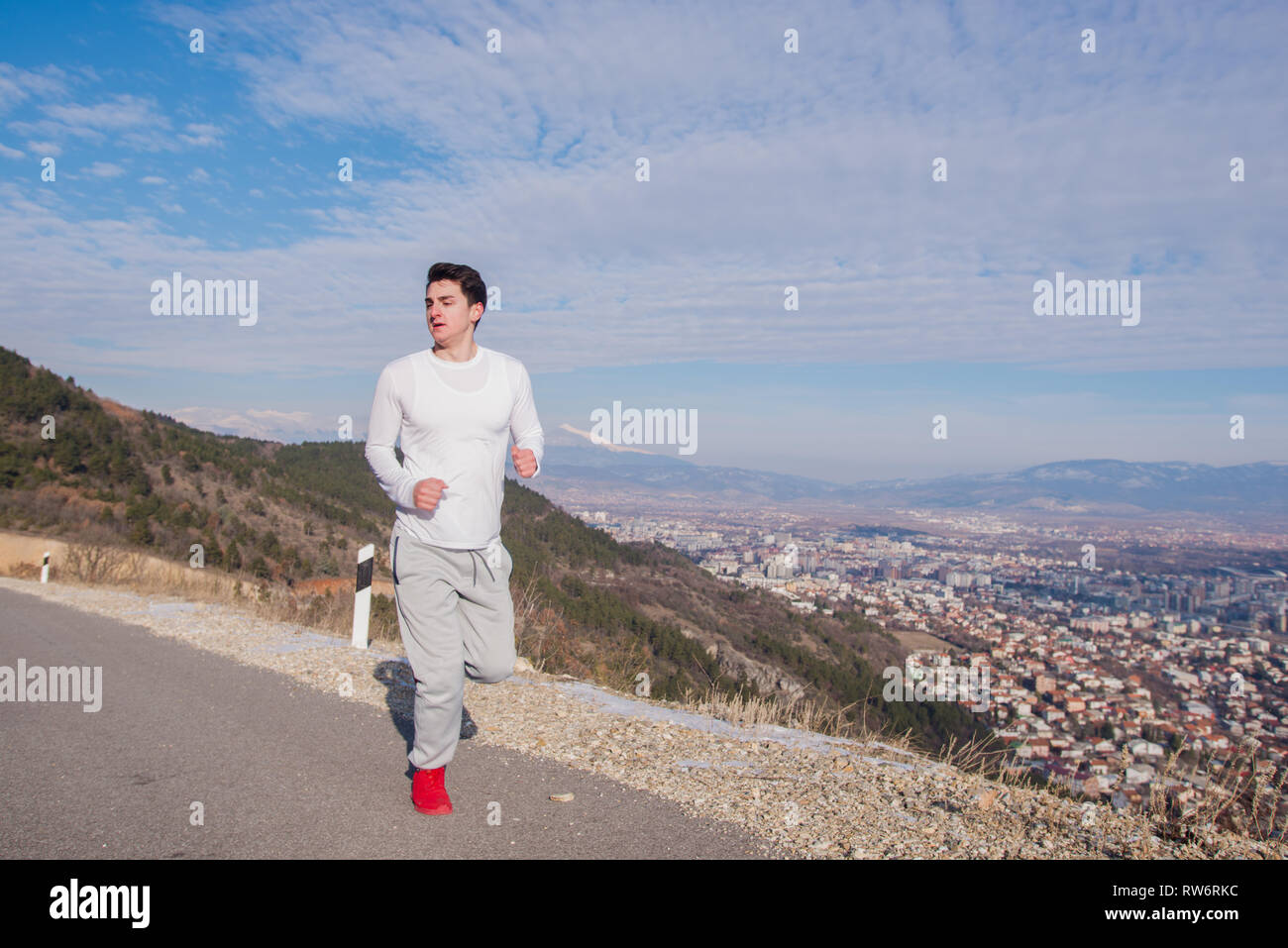 Fit man running down on an empty street on a sunny day Stock Photo - Alamy