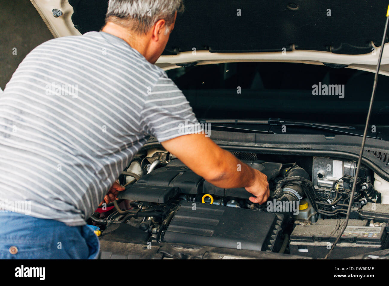 Hands of a man showing the inside of the car and the auto engine Stock ...