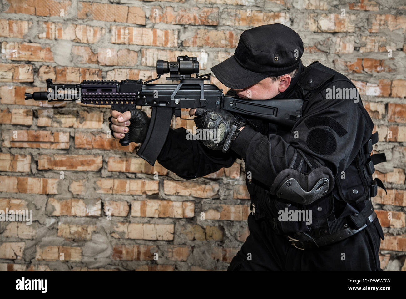 Special forces operator in black uniform and bulletproof vest Stock ...