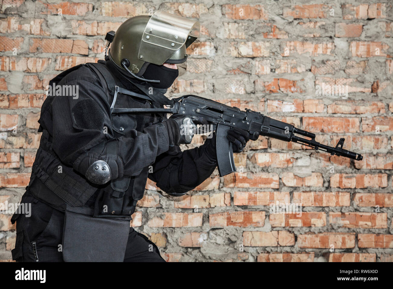 Special forces operator in black uniform and bulletproof vest Stock ...