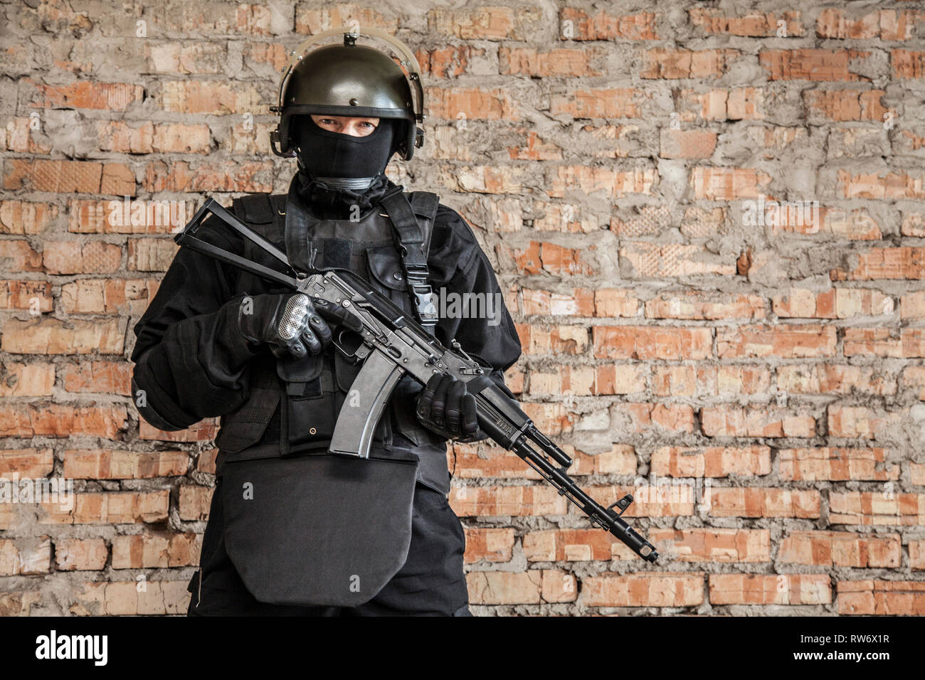 Special forces operator in black uniform and bulletproof vest Stock ...