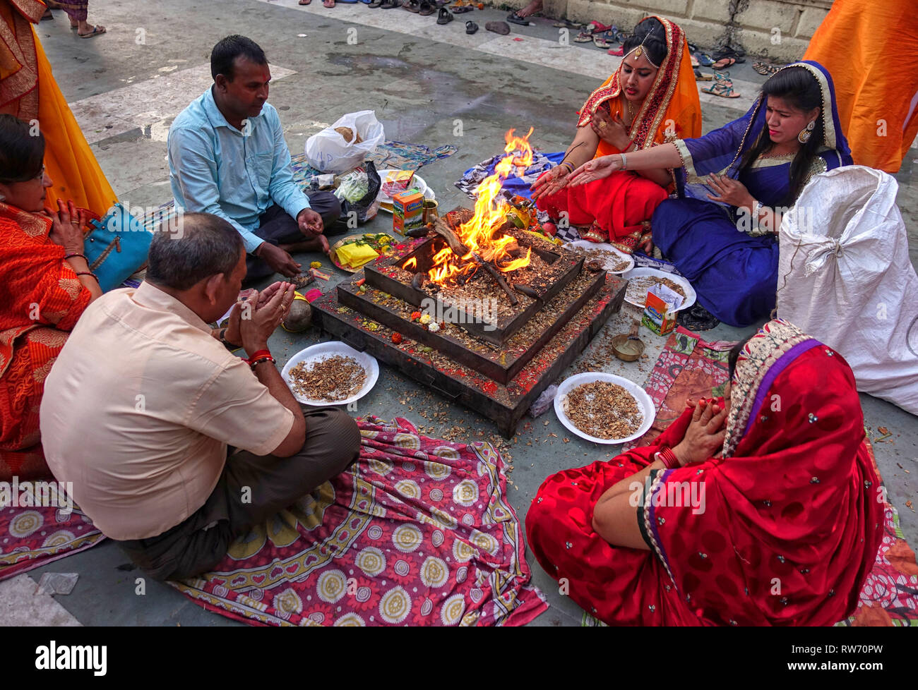 Hindu devotees seen praying while giving offering food on the idol of ...