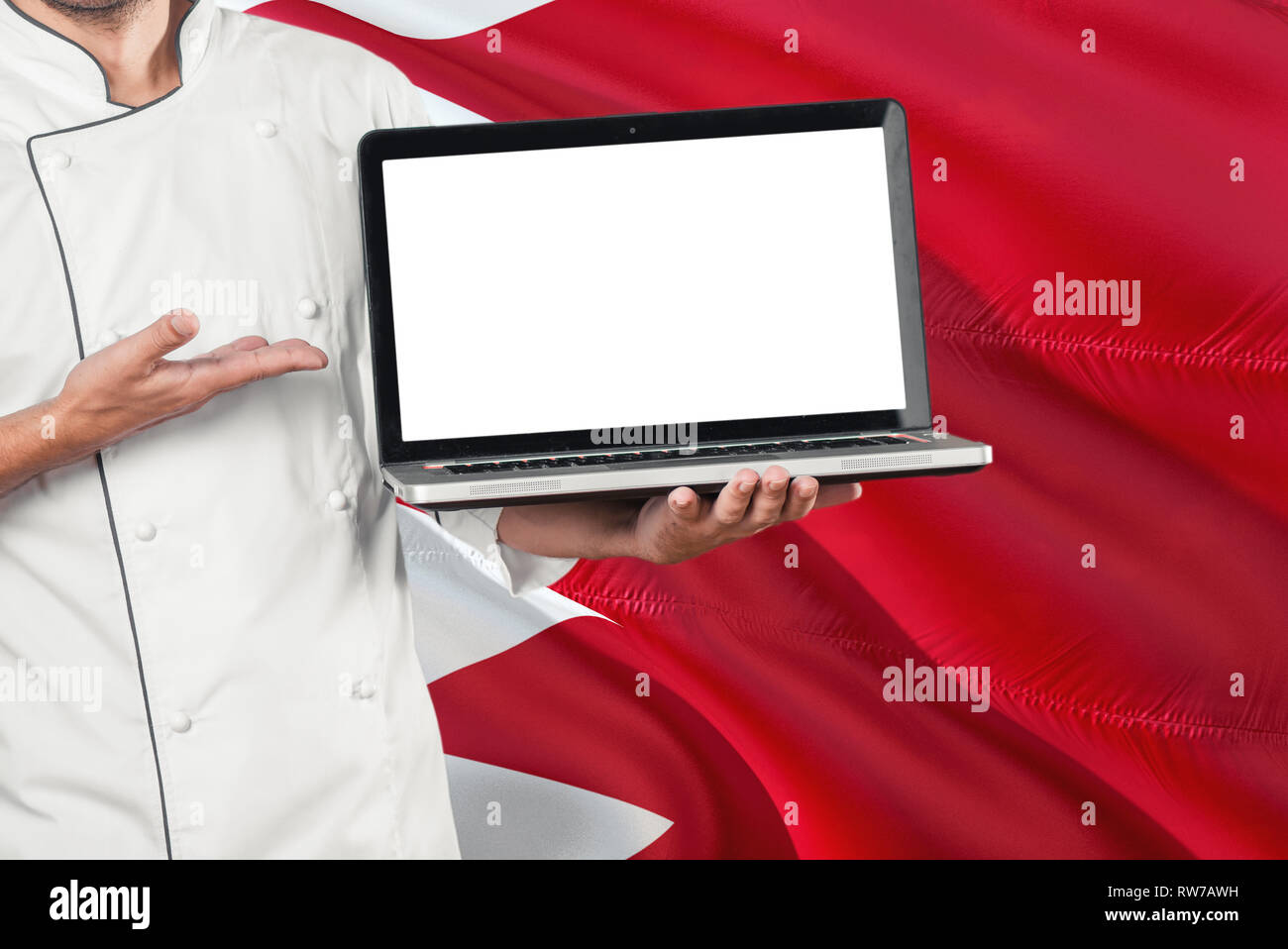 Bahraini Chef holding laptop with blank screen on Bahrain flag ...