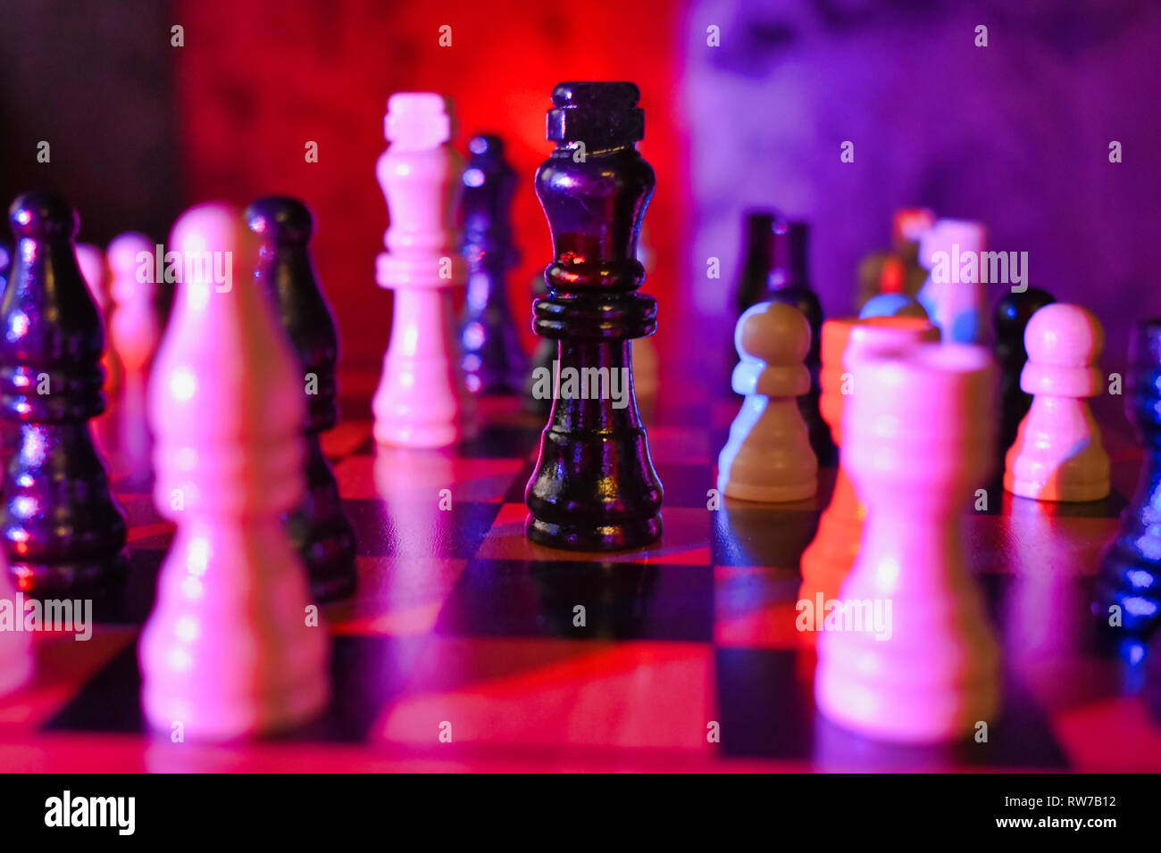 Red Blue Lit Chess Board with Focus on Black King Piece Static Shot ...