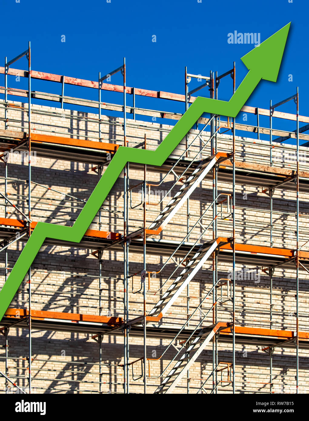 construction site scaffolding with stairway upwards and green arrow up ...