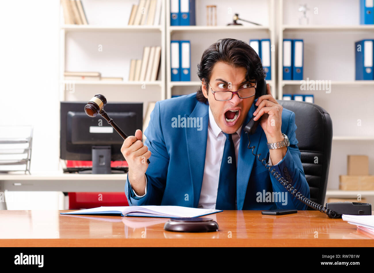 Young handsome judge sitting in courtroom Stock Photo - Alamy