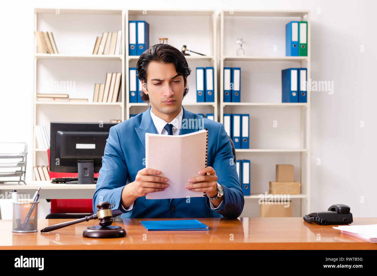 Young handsome judge sitting in courtroom Stock Photo - Alamy