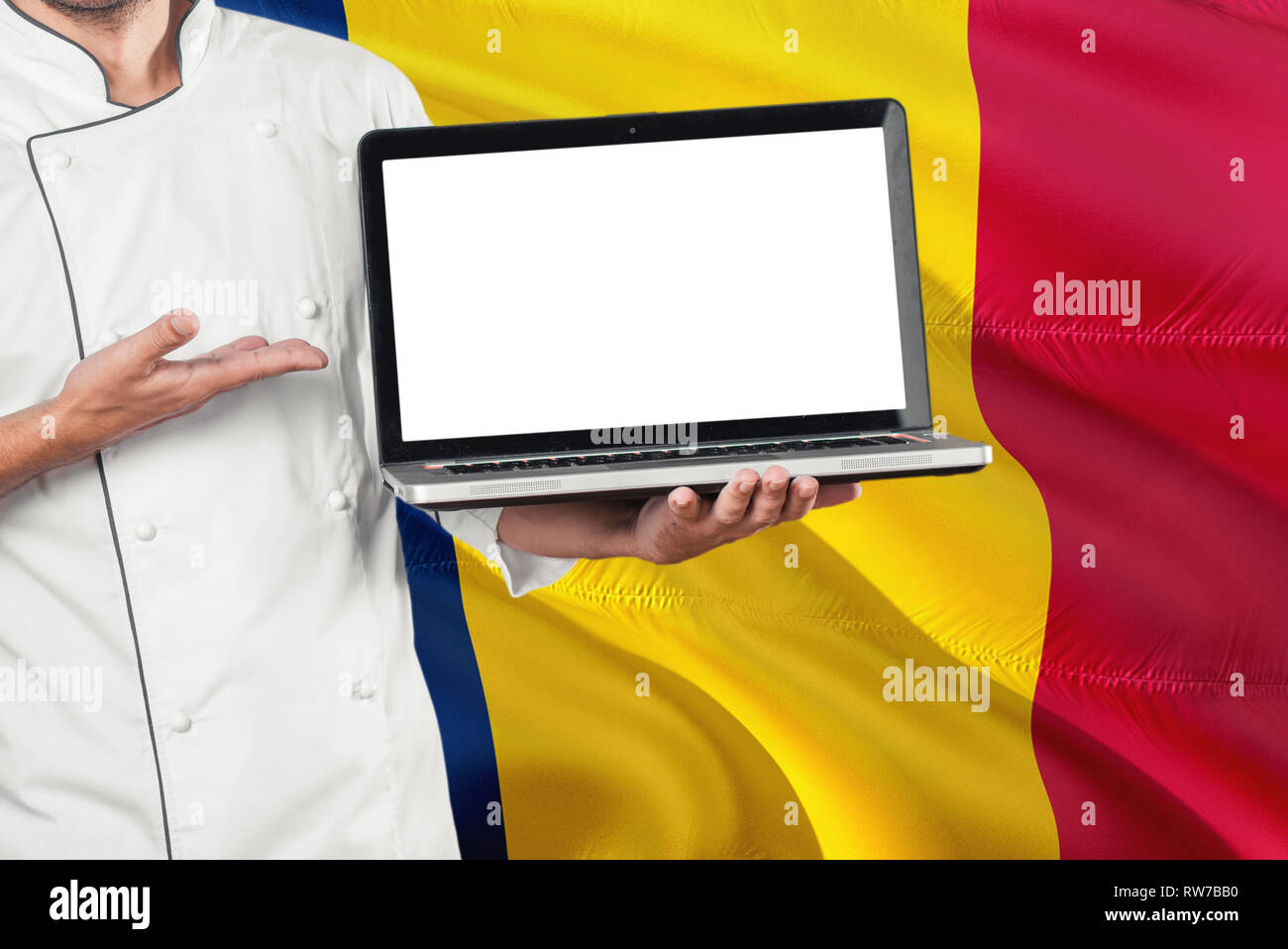 Chadian Chef holding laptop with blank screen on Chad flag background ...
