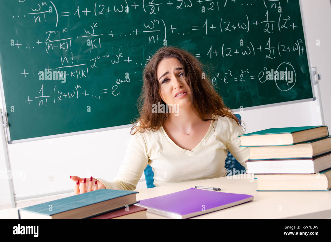 Young female math teacher in front of chalkboard Stock Photo - Alamy