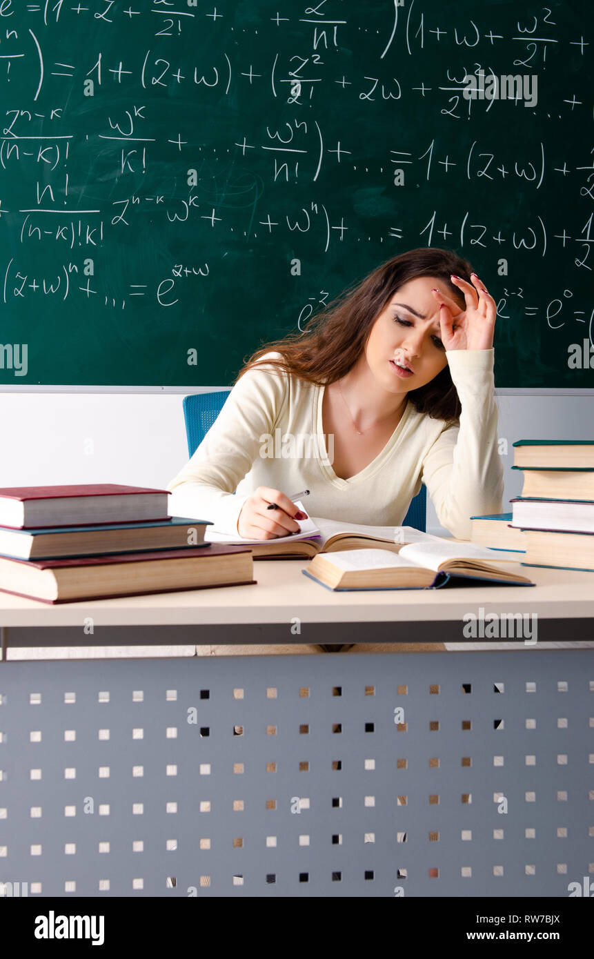 Young female math teacher in front of chalkboard Stock Photo - Alamy