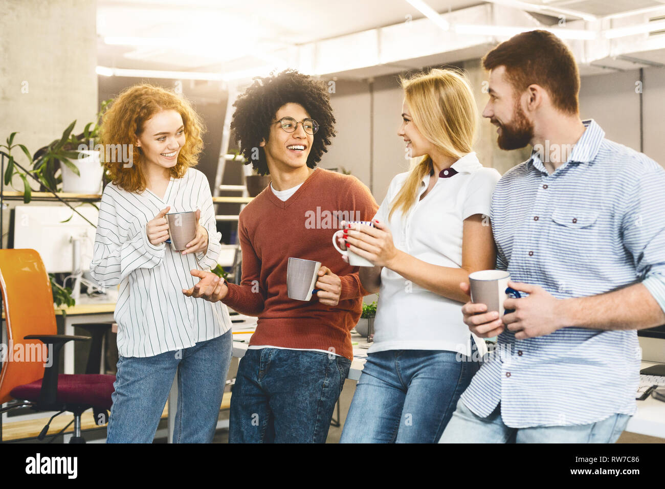 Cheerful colleagues enjoying coffee break in office Stock Photo - Alamy Cheerful colleagues enjoying coffee break in office Stock Photo - Alamy