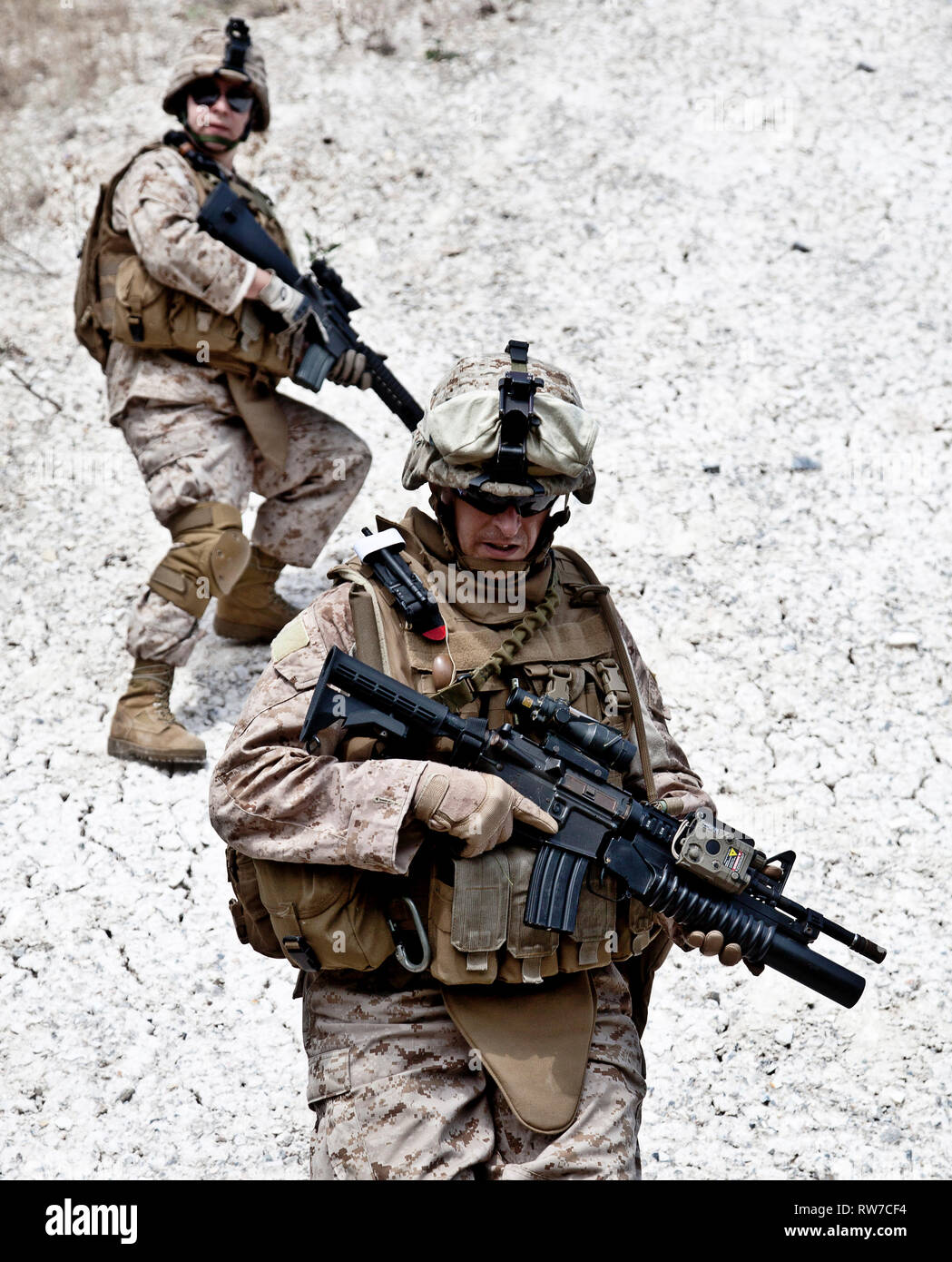 Two soldiers in the mountains during a military operation Stock Photo ...
