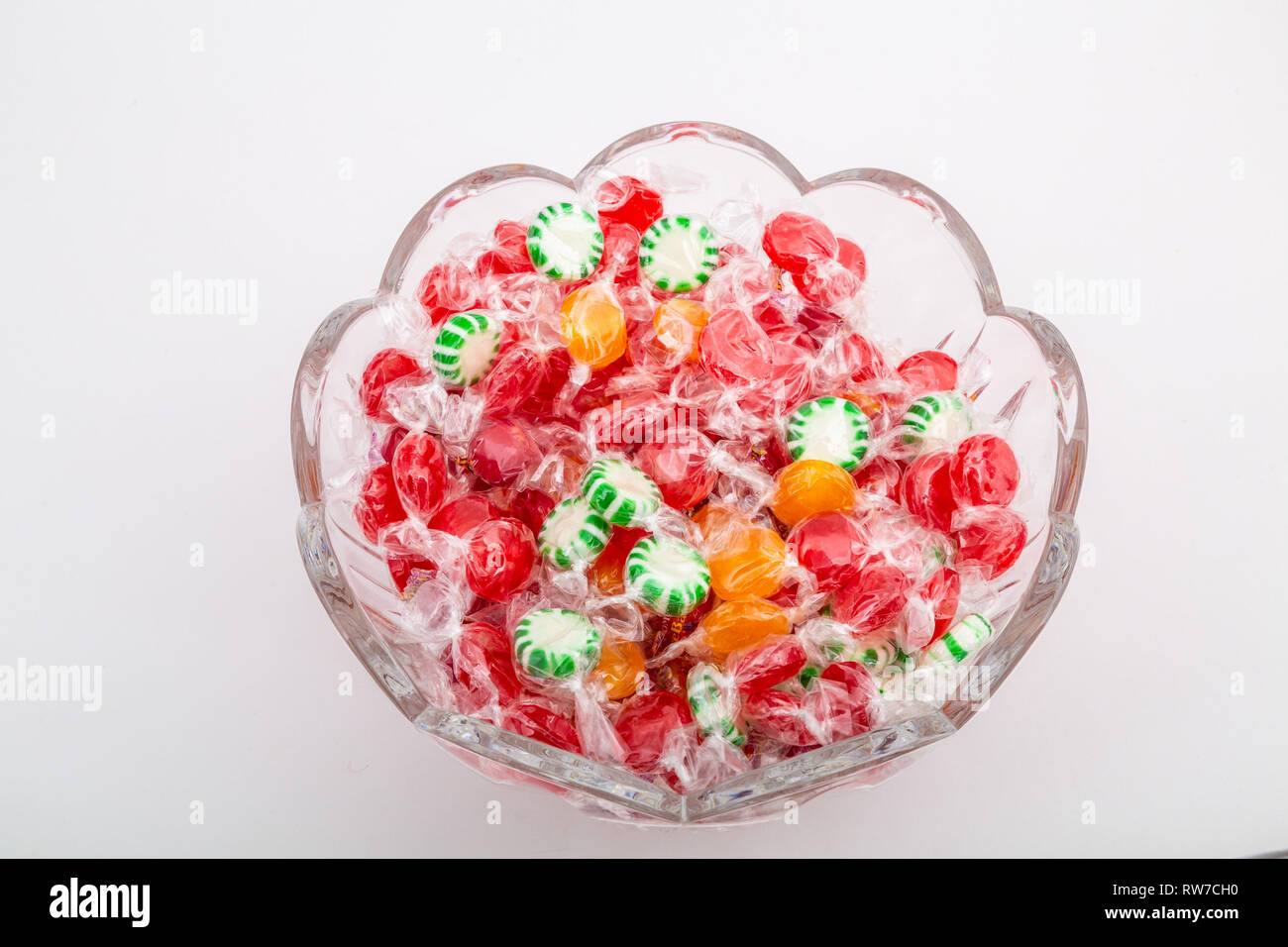 A cut glass bowl full of various wrapped candies and mints Stock Photo ...