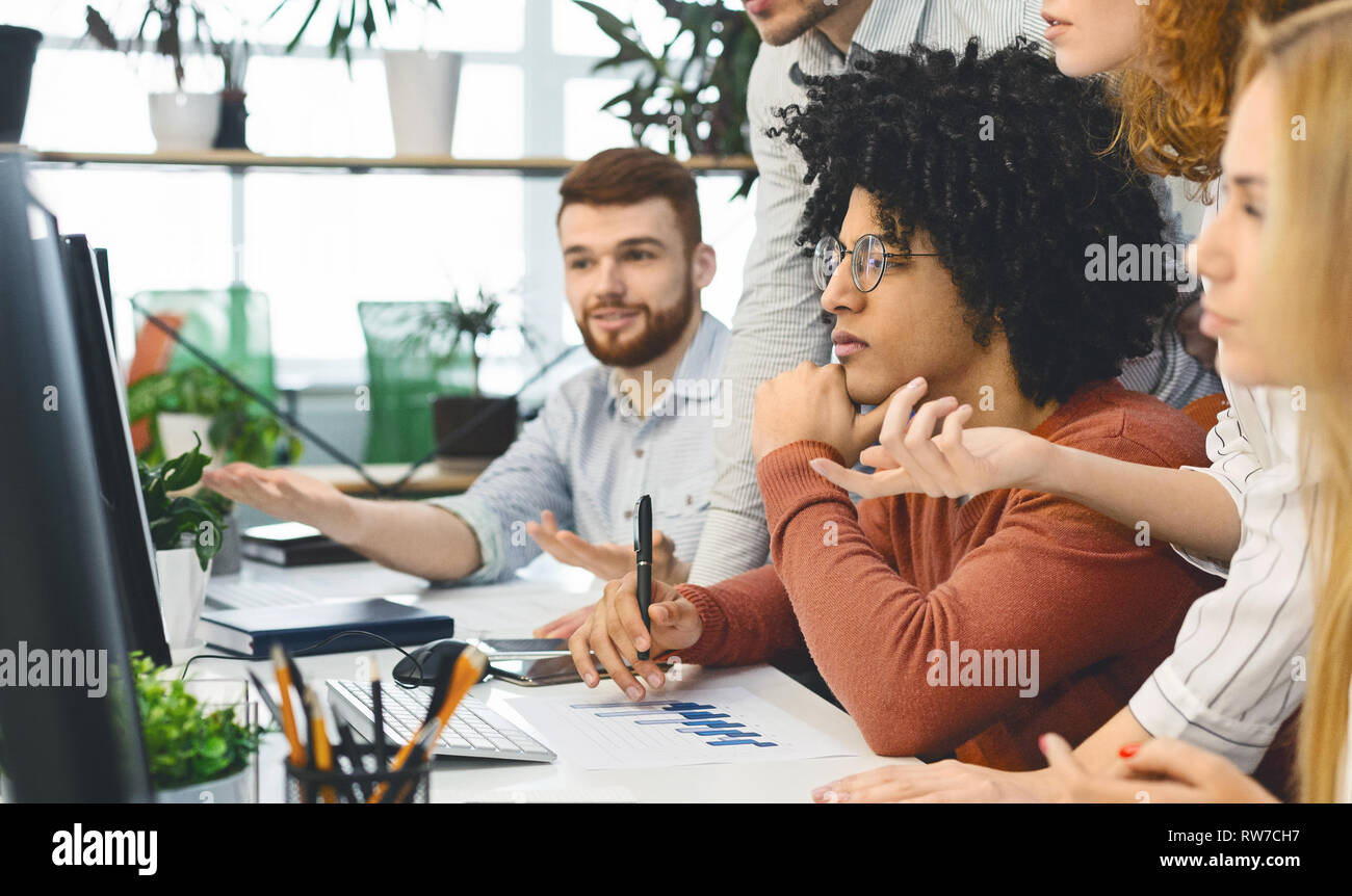 Millennial team working with new project on computer screen Stock Photo ...