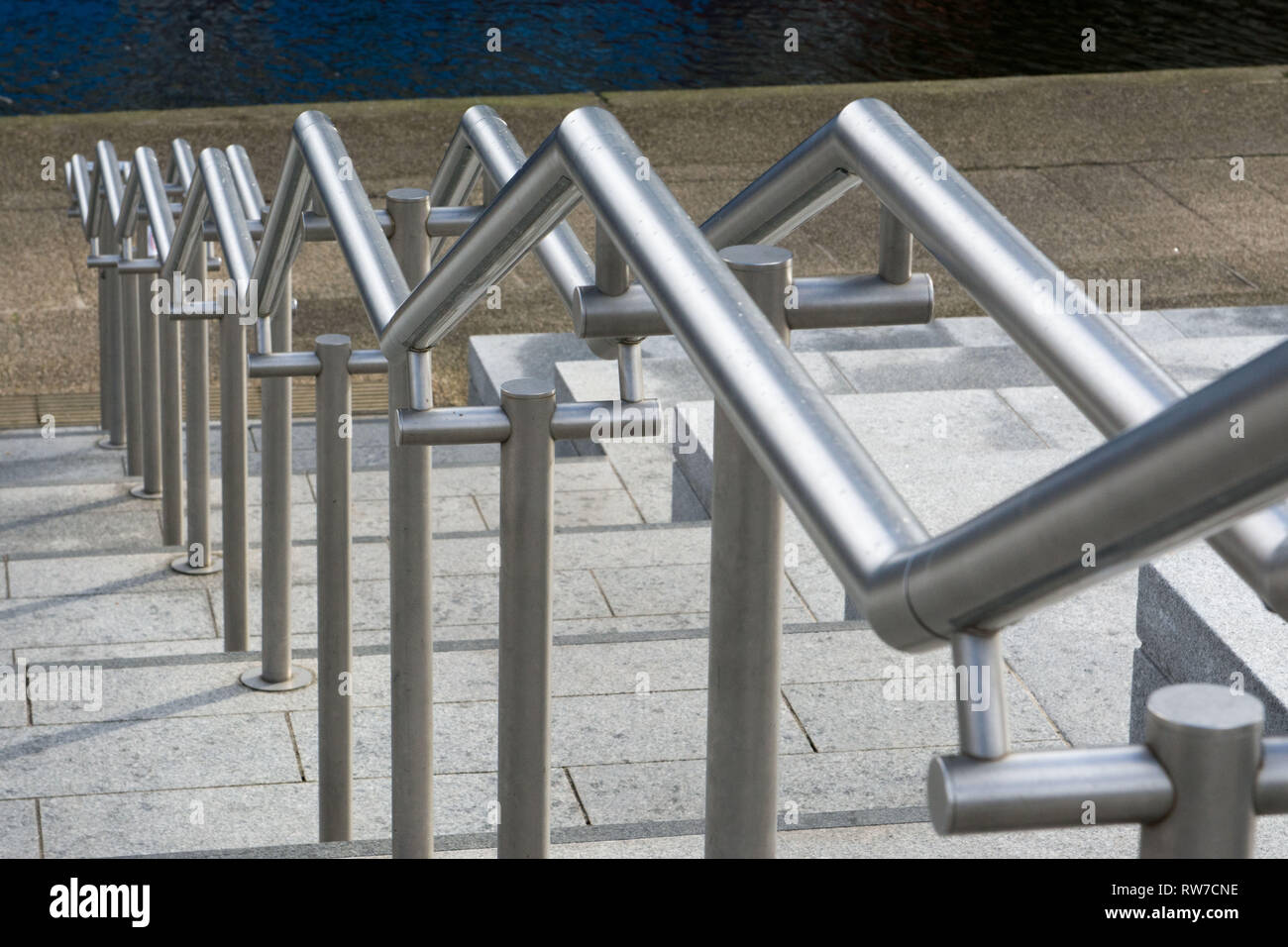 Metal shaped outdoor stair hand rail Stock Photo - Alamy