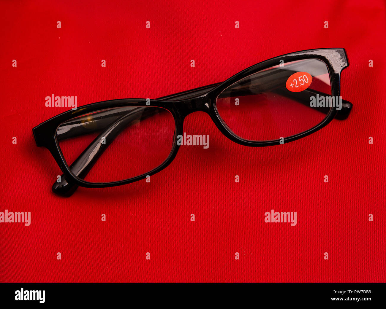 Power 2.50 Reading Glasses on a red background Stock Photo - Alamy