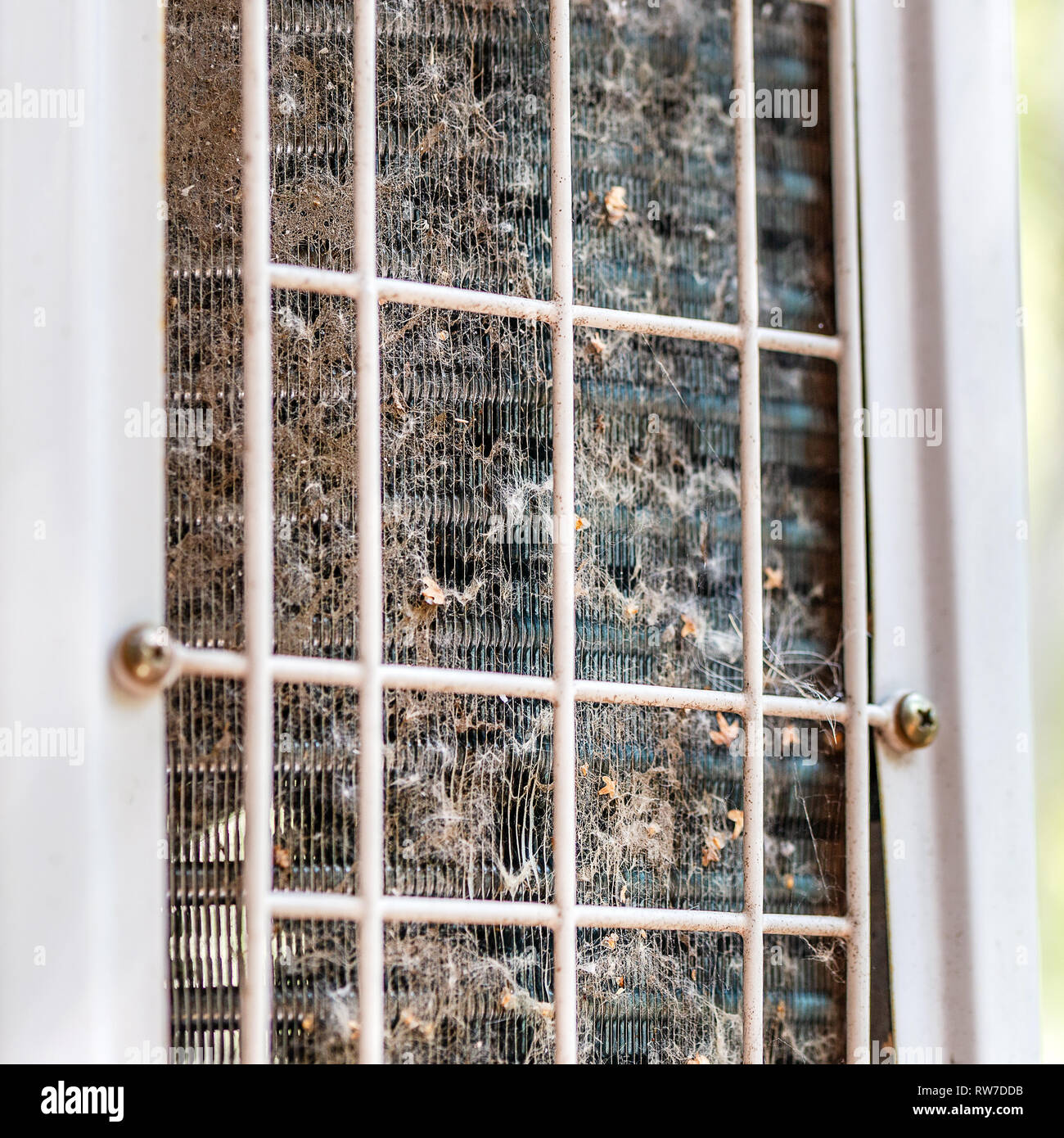 Close-up outdoor air condition unit with clogged obstructed compressor ...