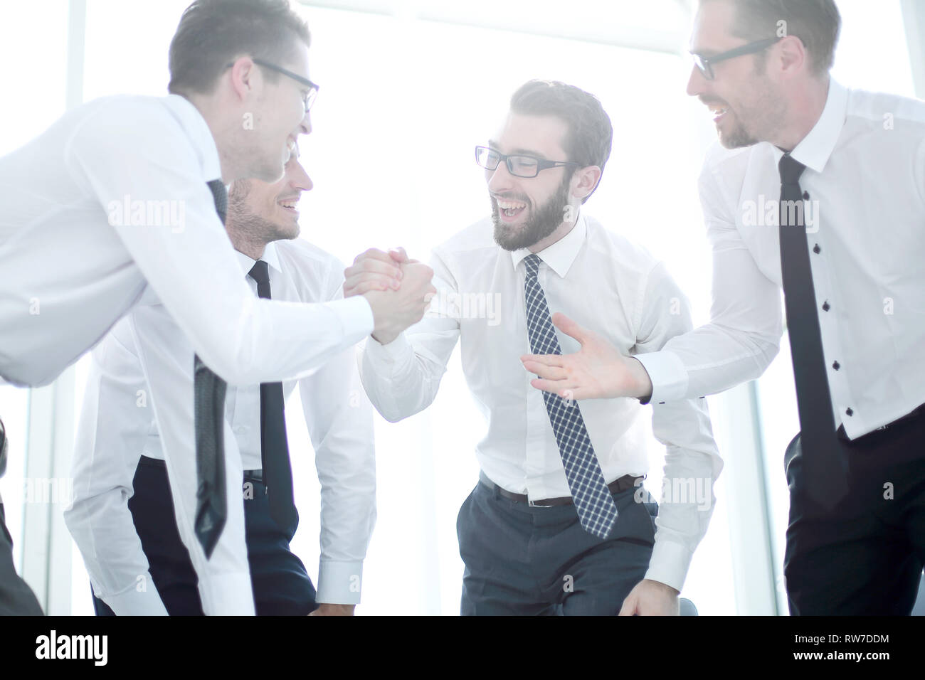 close up.happy employees shaking hands Stock Photo - Alamy
