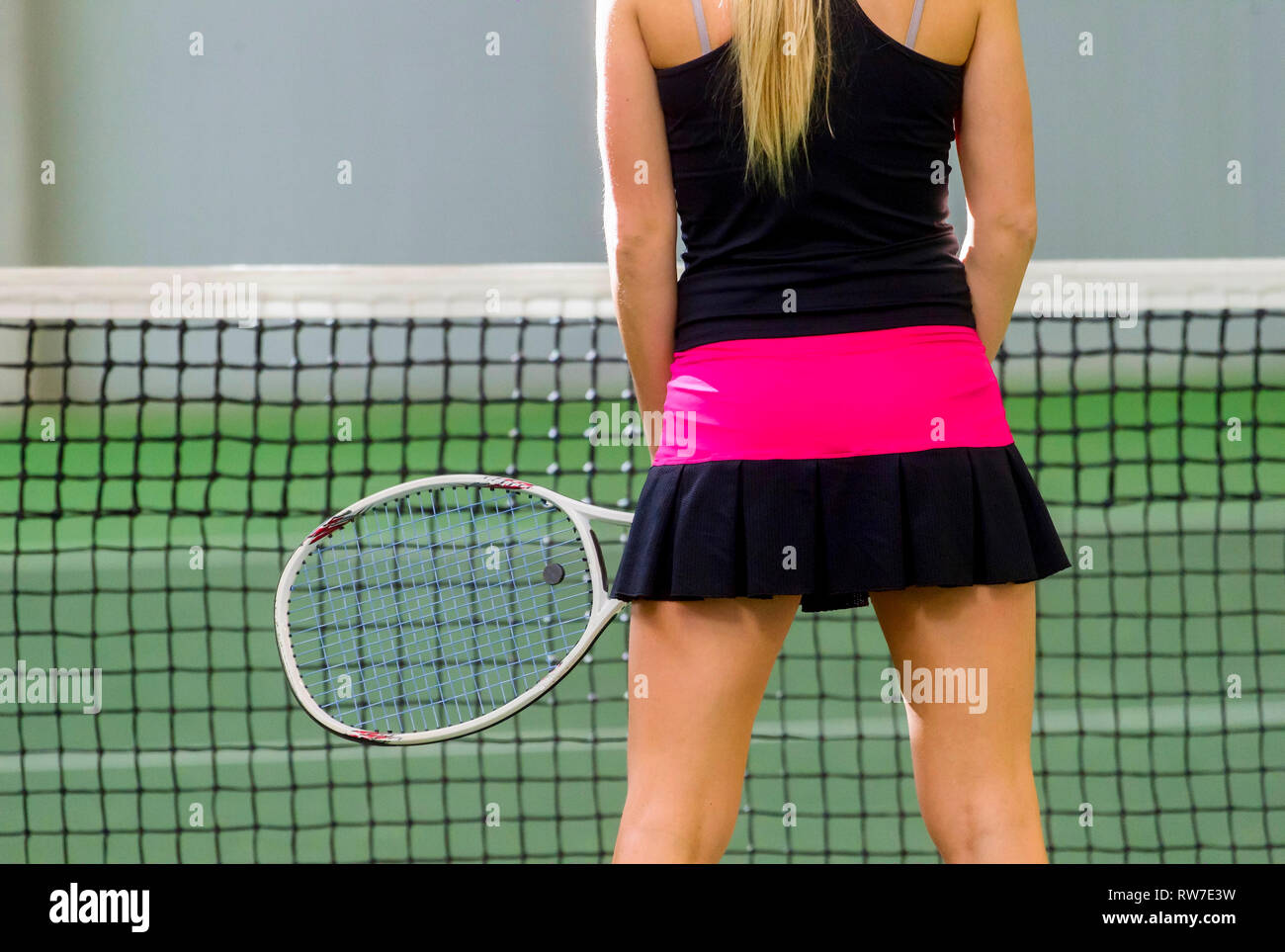 back view of a female tennis player with a racket in action Stock Photo ...