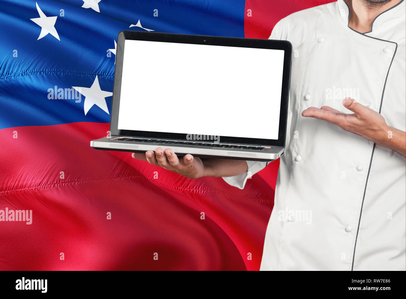 Samoan Chef holding laptop with blank screen on Samoa flag background ...