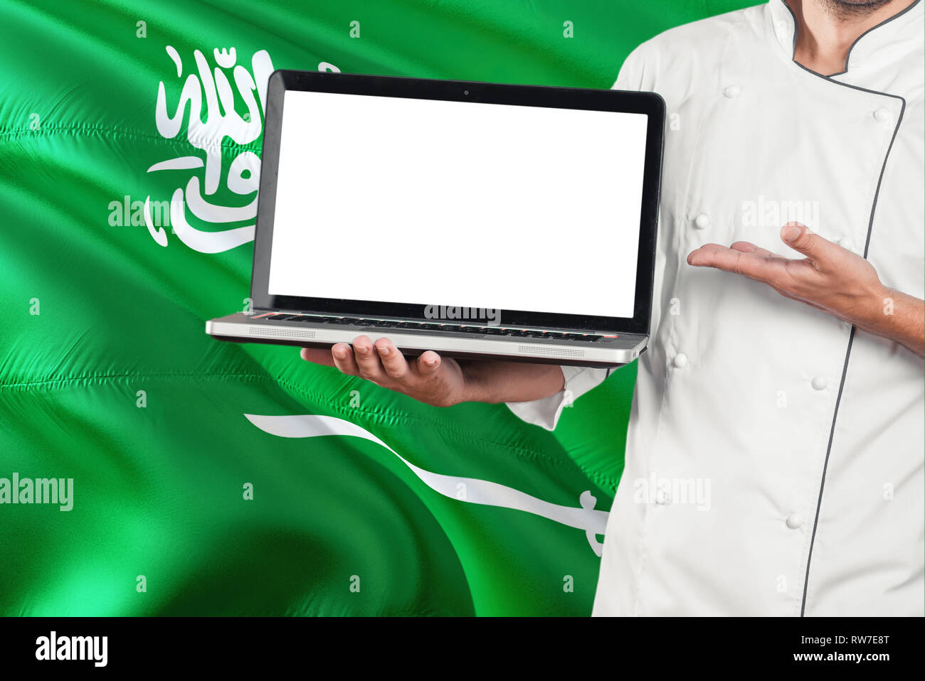 Saudi Chef holding laptop with blank screen on Saudi Arabia flag ...